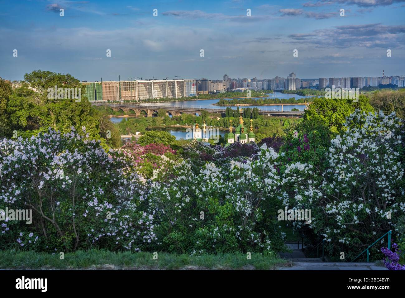 Scenic spring view of Kyiv with blooming lilacs, golden domes of ...