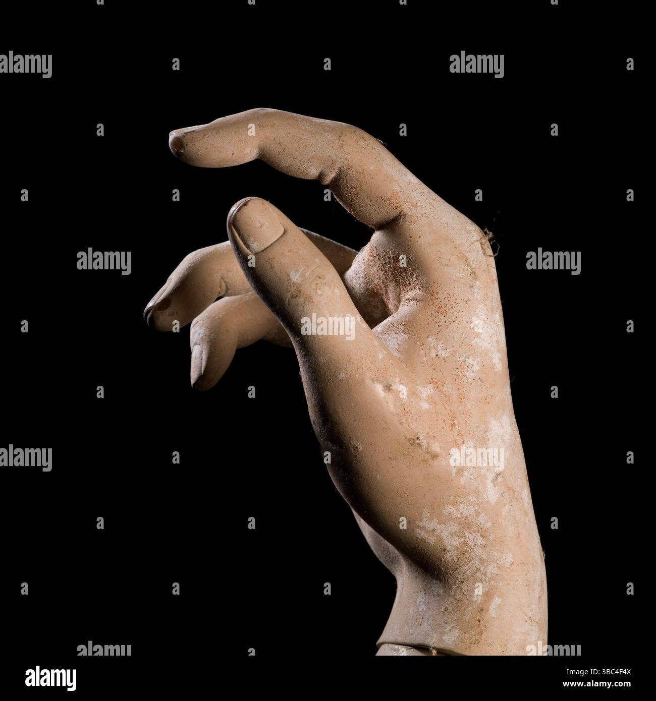 A detailed view of a mannequin hand with fingers slightly curled ...