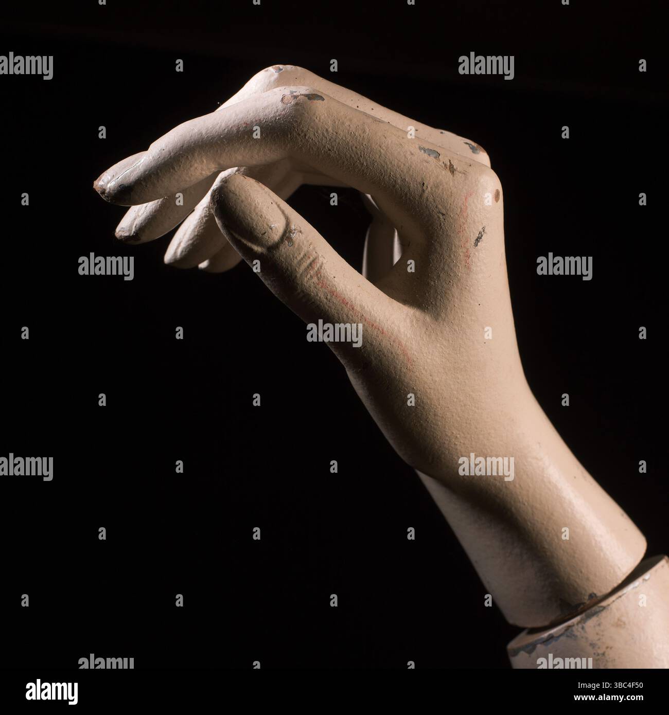 A detailed view of a mannequin hand with fingers slightly curled ...