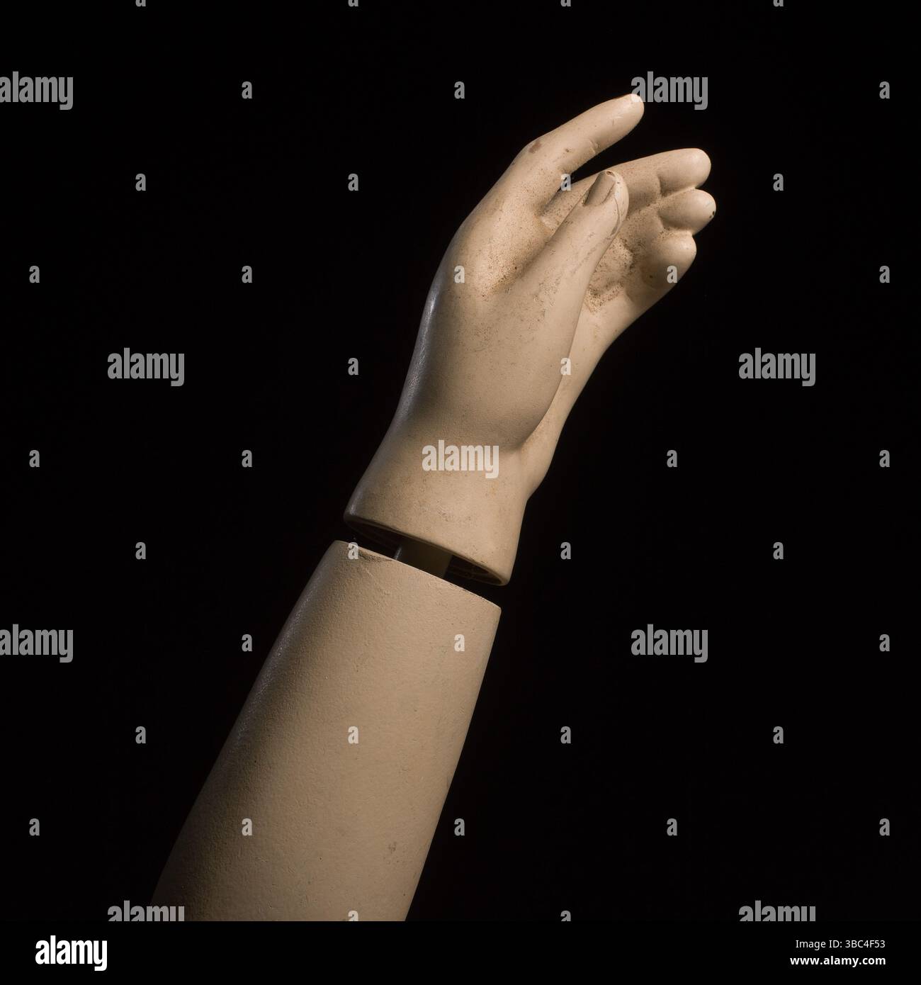 A detailed view of a mannequin hand with fingers slightly curled ...