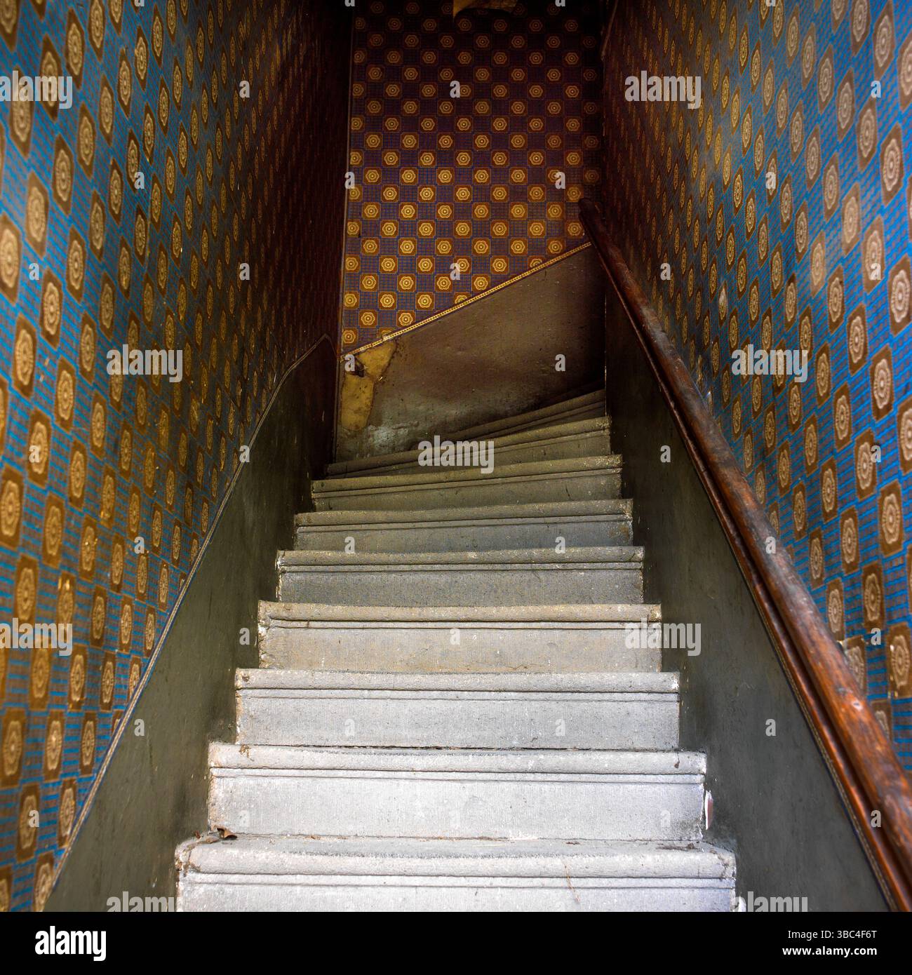 Staircase features worn steps and a dark atmosphere, going down to a ...