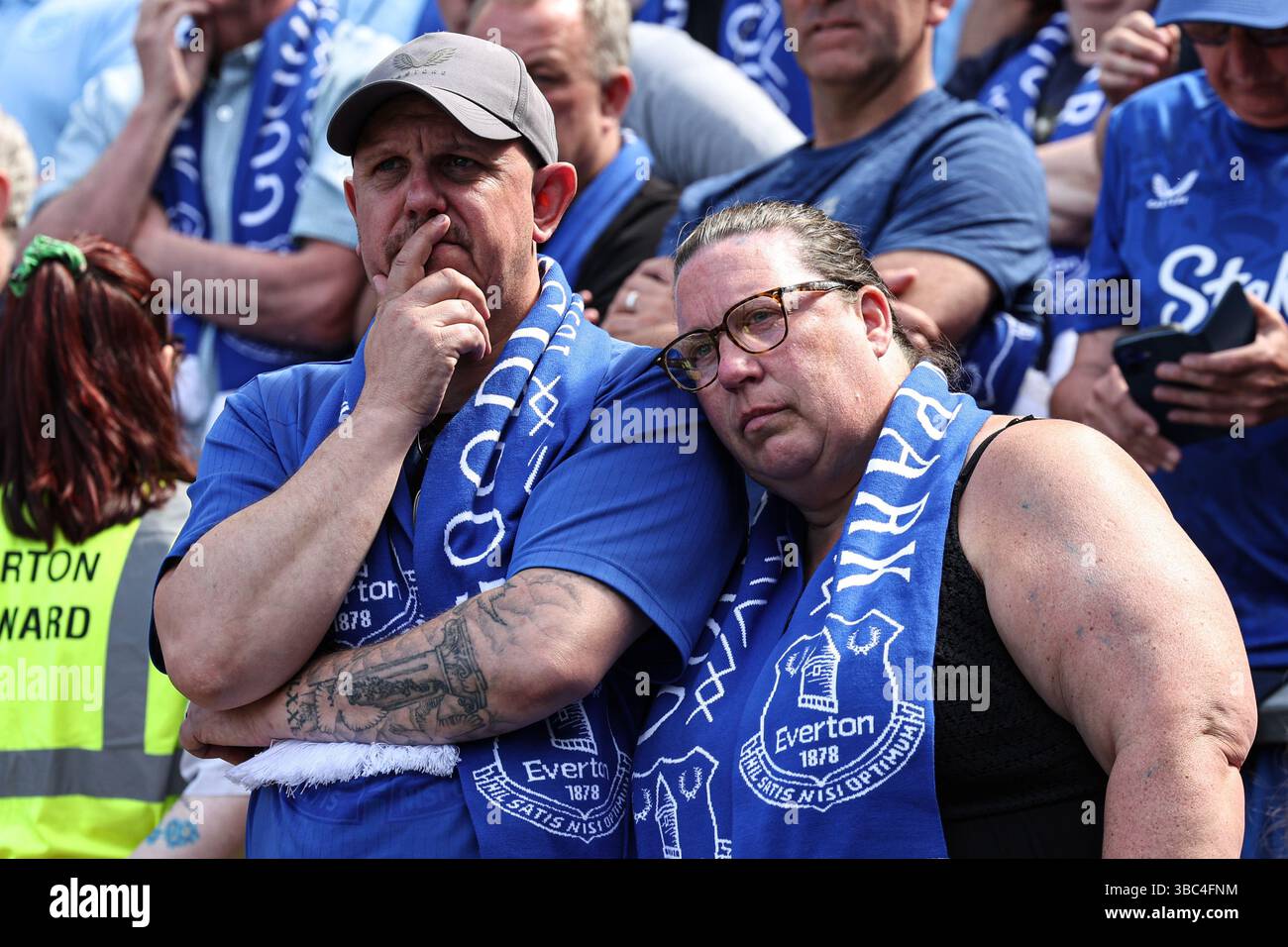 Liverpool, UK. 18th May, 2025. Two Everton fans embrace with a sad look ...