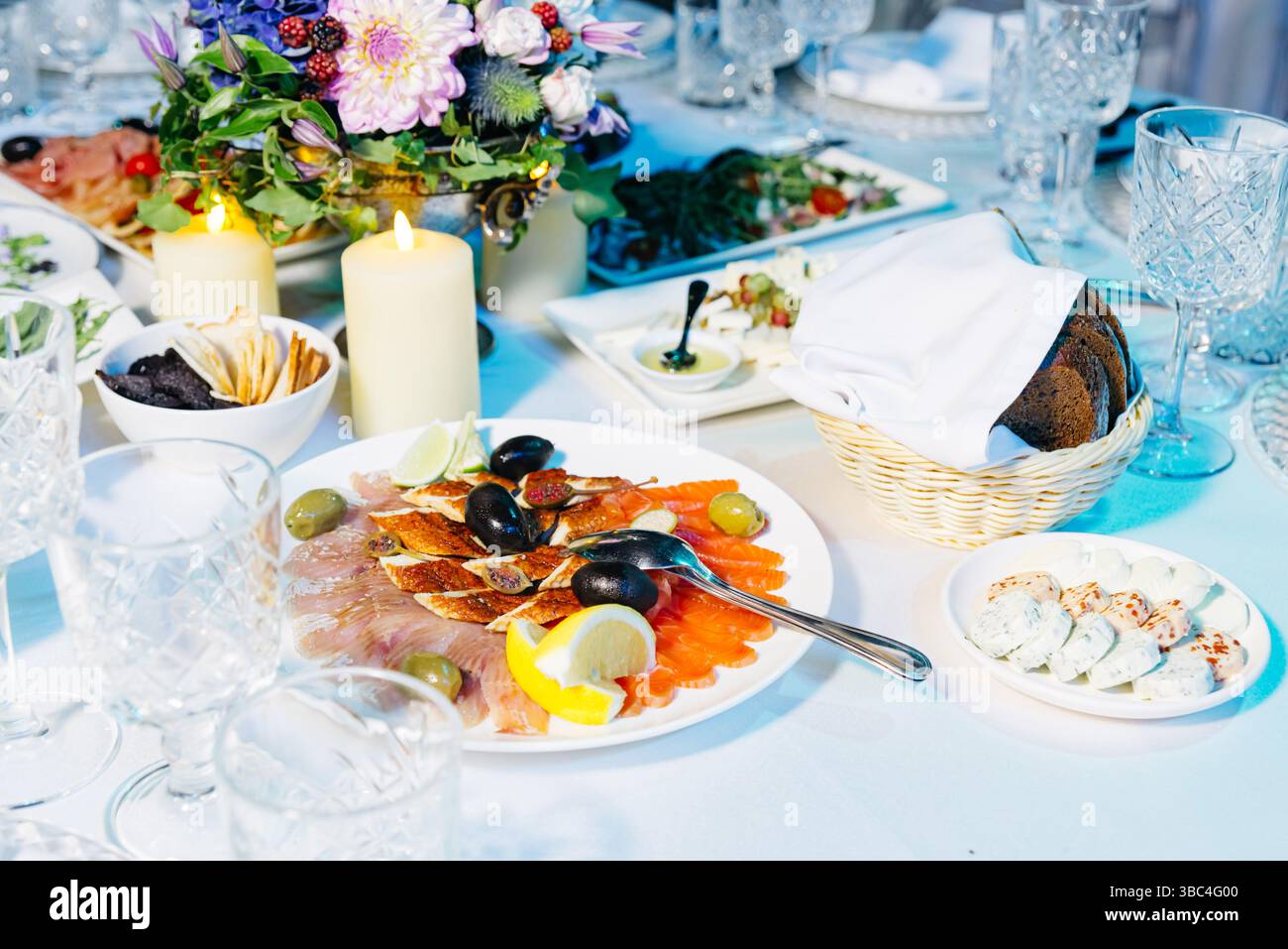 Upscale banquet table featuring an assortment of smoked fish, bread ...