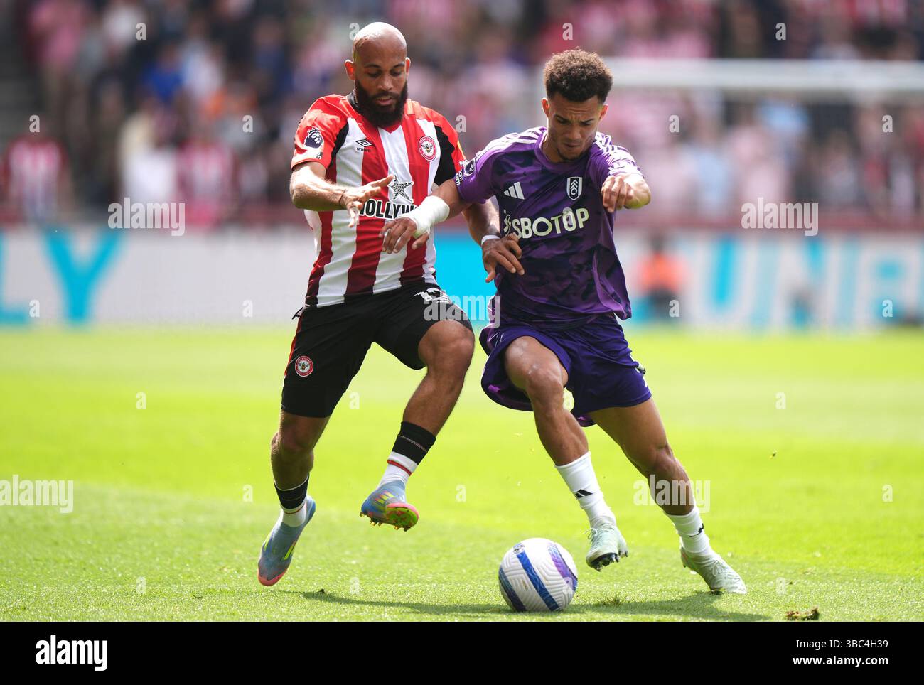 Brentford's Bryan Mbeumo (left) and Fulham's Antonee Robinson battle ...