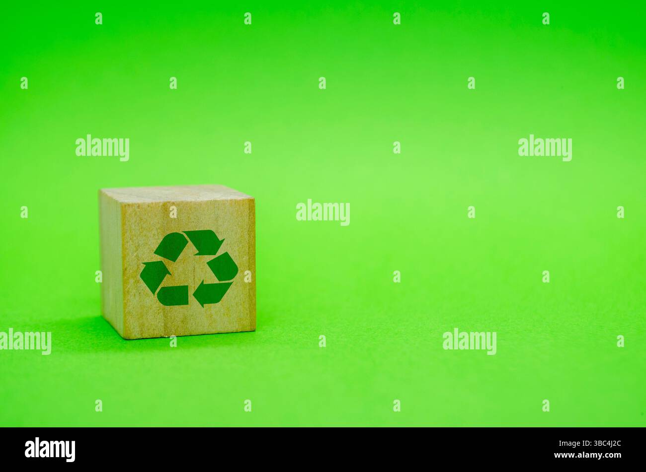 Recycle symbol with wooden blocks on green background. Promoting reuse ...