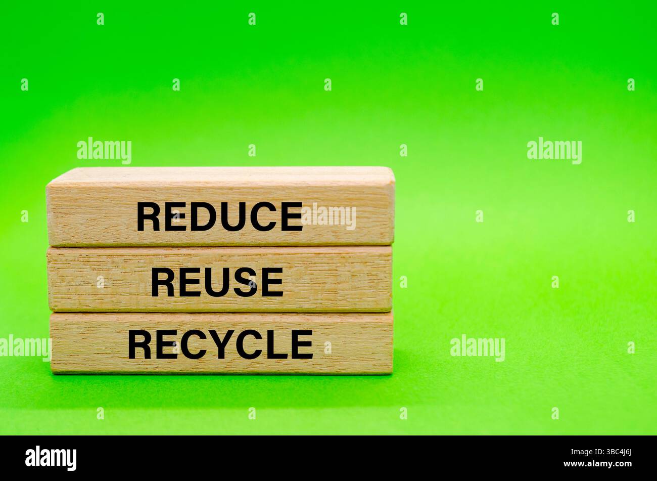 Wooden blocks with Reduce, Reuse and Recycle text placed on green ...