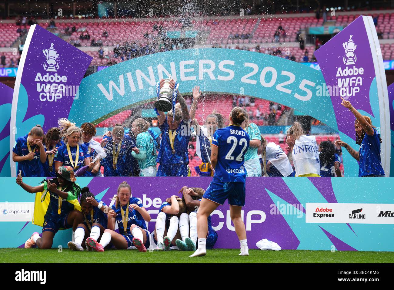 Chelsea's Millie Bright (centre) lifts the FA Cup trophy as team-mate ...