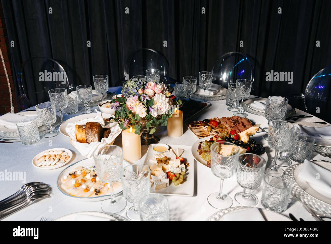 Formal dining table set with crystal glassware, floral centerpiece ...