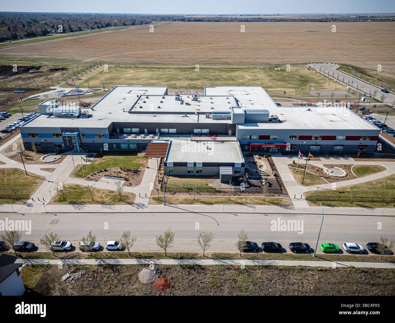 Large building with a lot of windows and a white roof. The building is ...