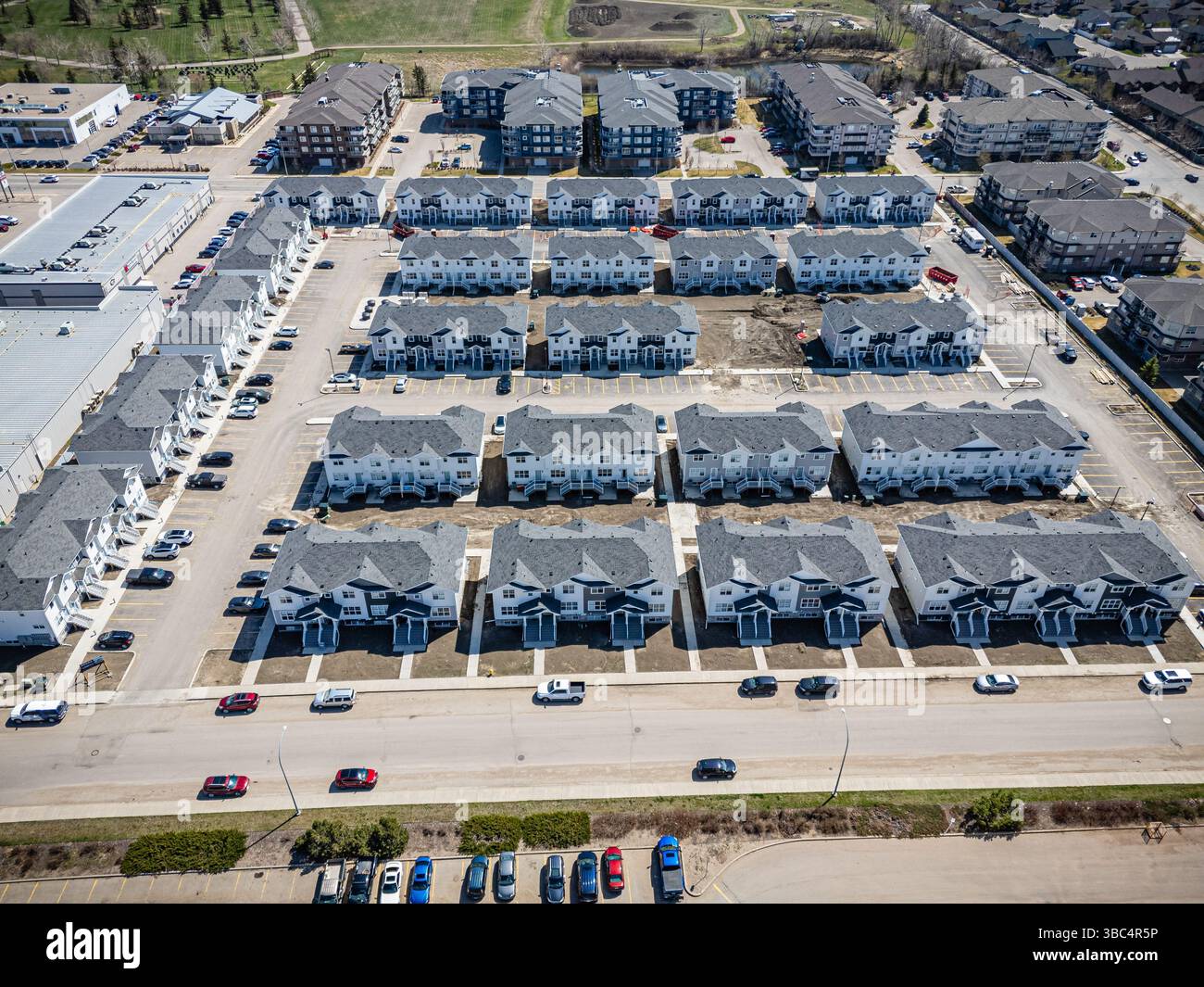 Large residential area with many houses and cars. The houses are mostly ...