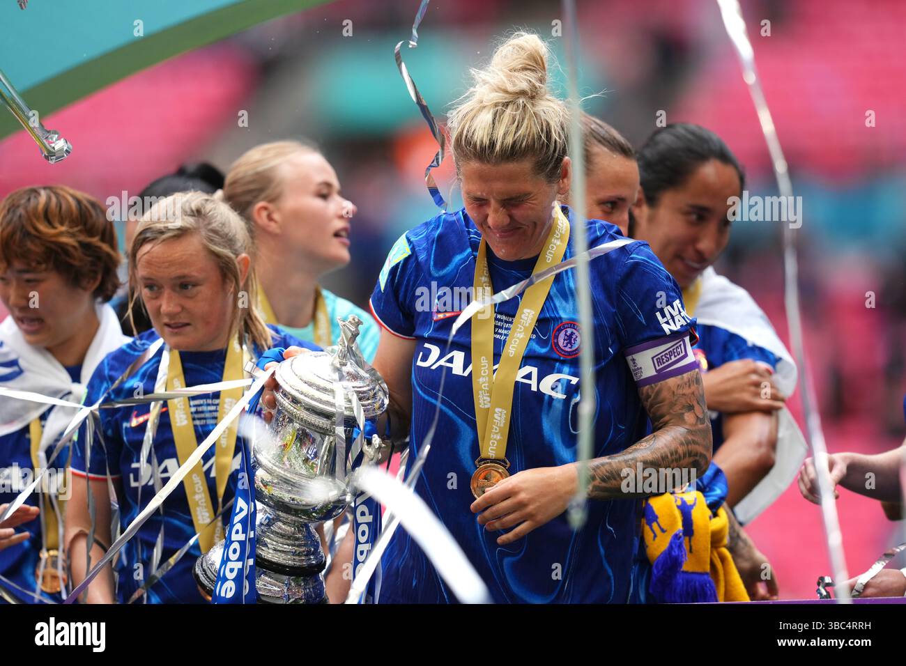 Chelsea's Millie Bright (centre) with the FA Cup trophy following ...