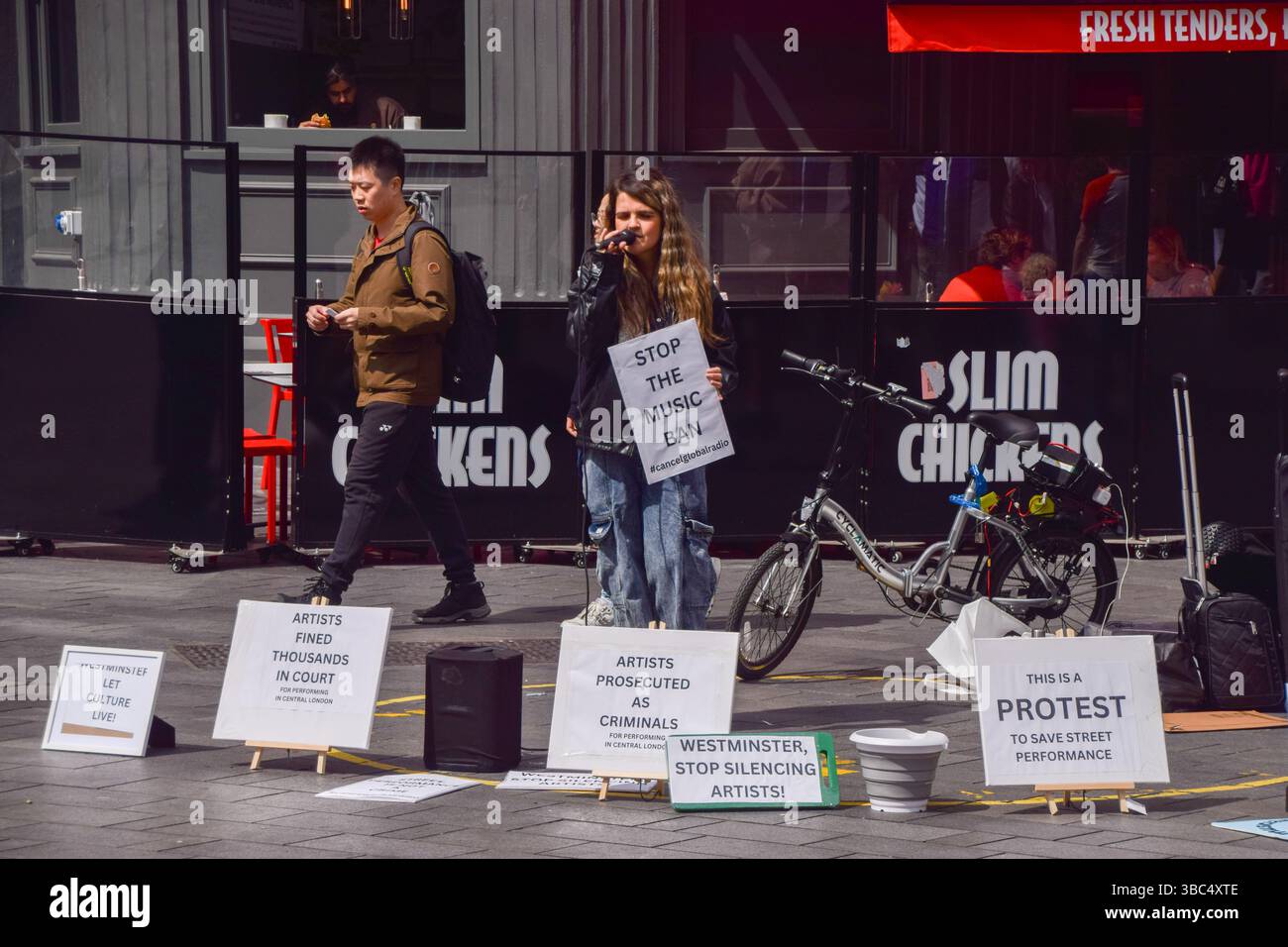 London, UK. 18th May 2025. A busker performs in Leicester Square in ...