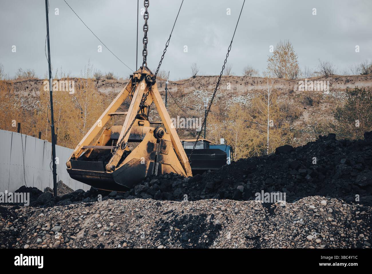 Excavator crane is engaged in loading and unloading coal at a busy ...