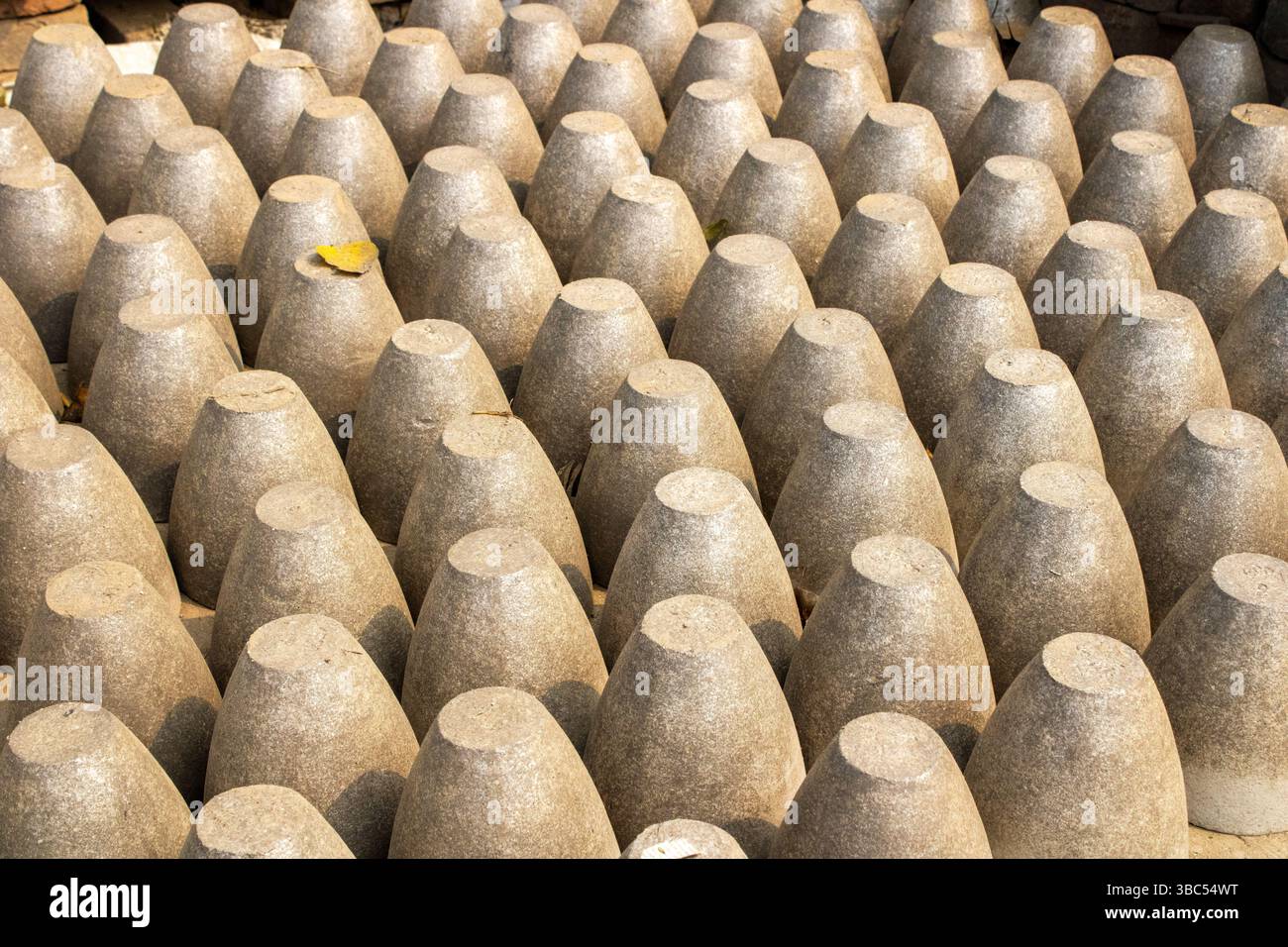 A symmetrical arrangement of concrete pots sprayed for drying and ...