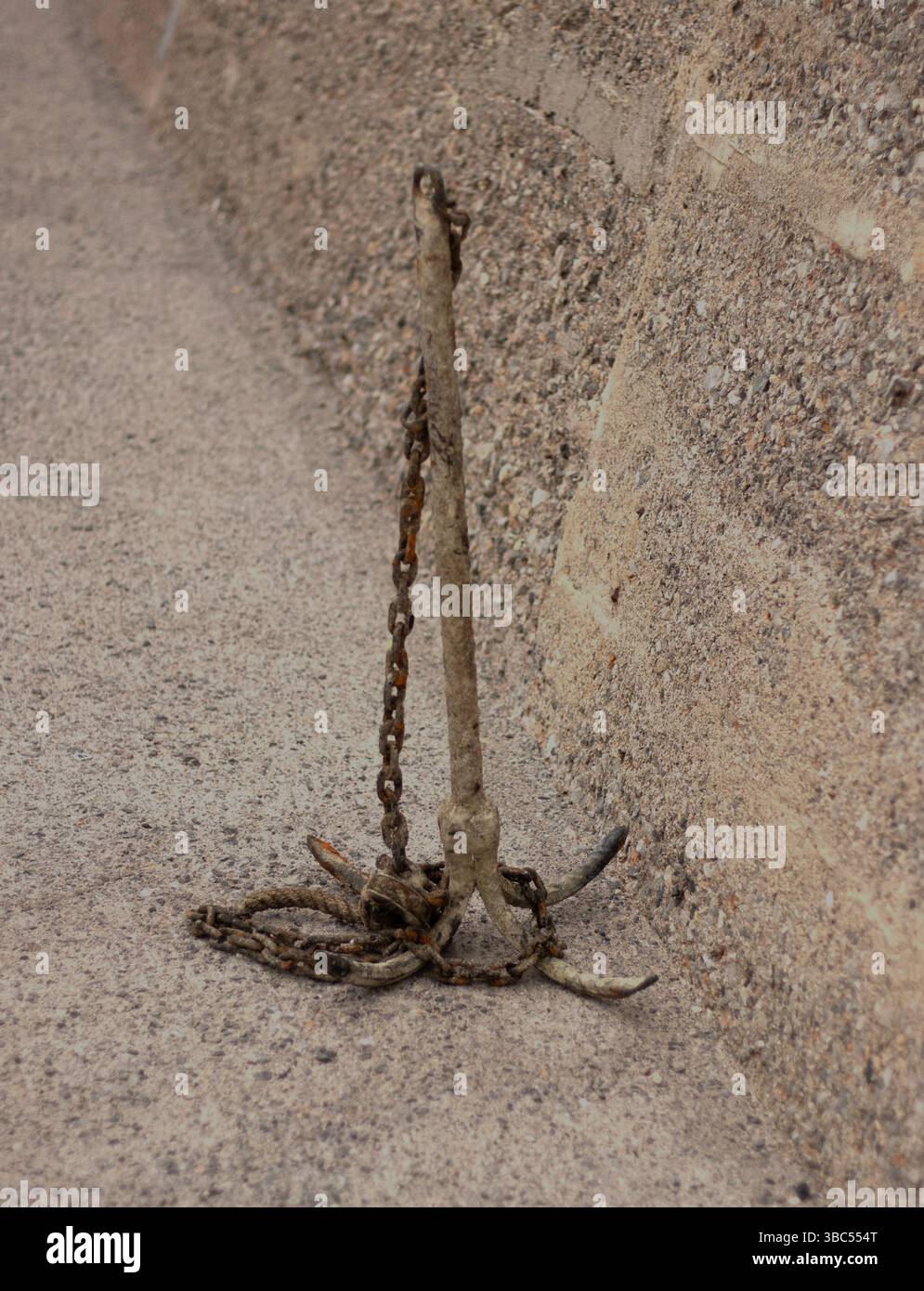 old rusty anchor with chain. Ship anchor an screw lying on the ...