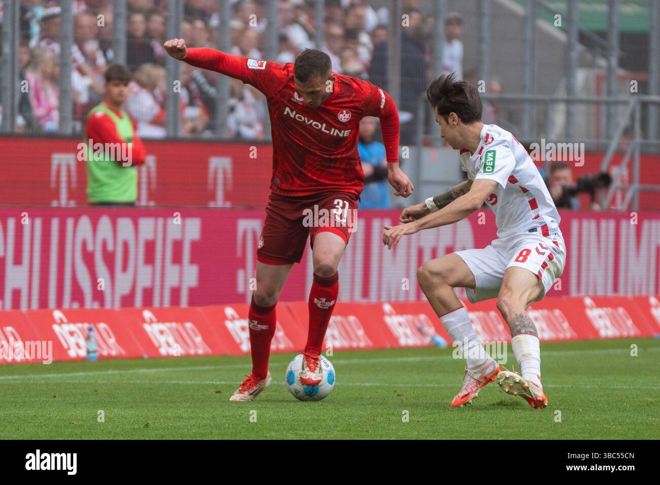 Koeln, Deutschland. 18th May, 2025. Luca Sirch (1. FC Kaiserslautern, #31) im Zweikampf mit ...