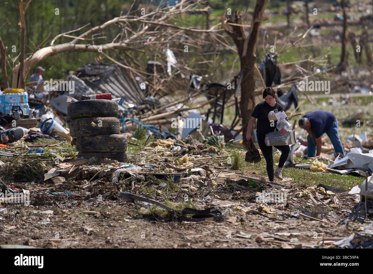 Macey Coffey carries salvageable items from what isleft of Edwina ...