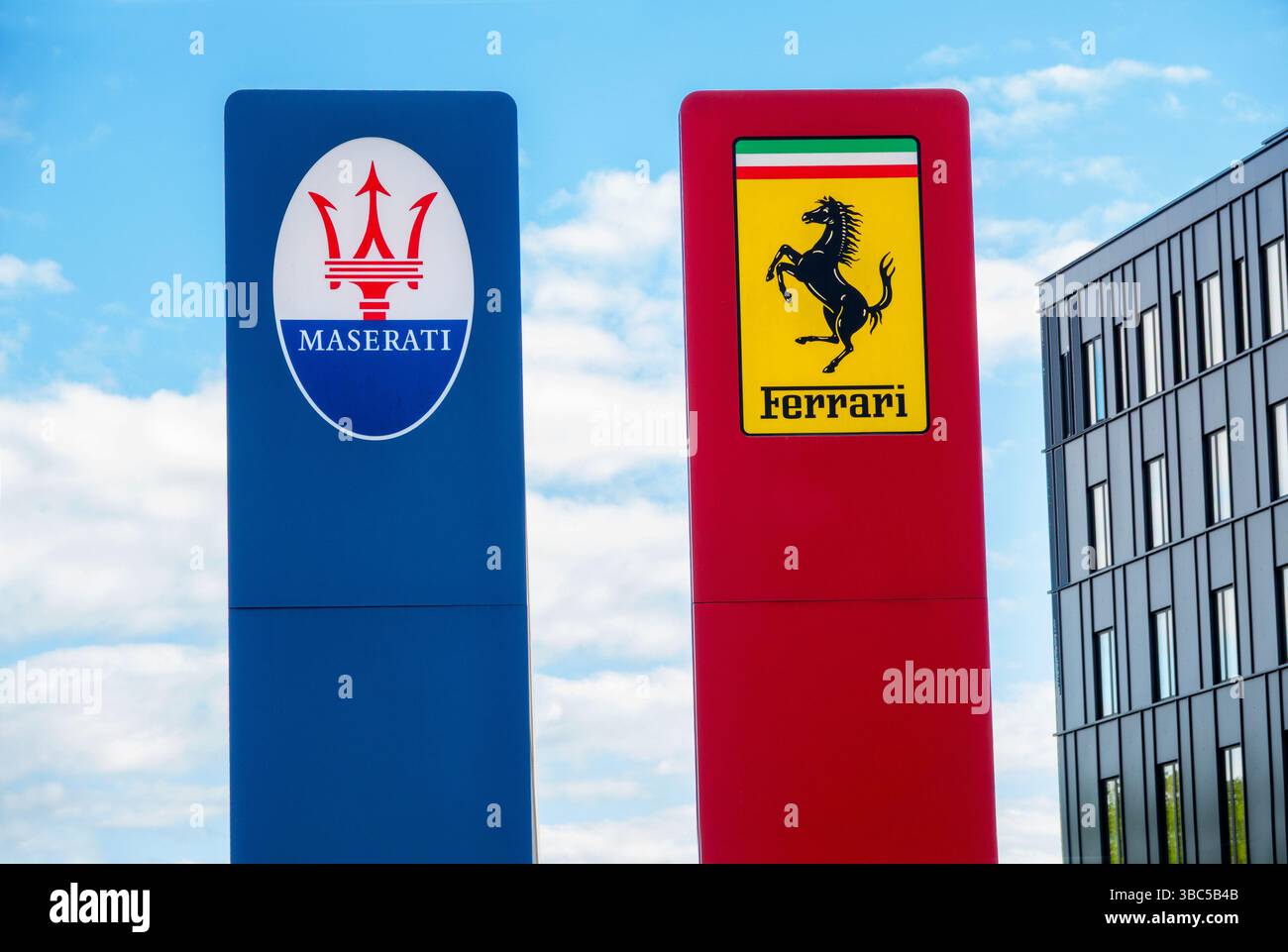 Totem signage of Italian sports car brands Maserati and Ferrari dealer ...