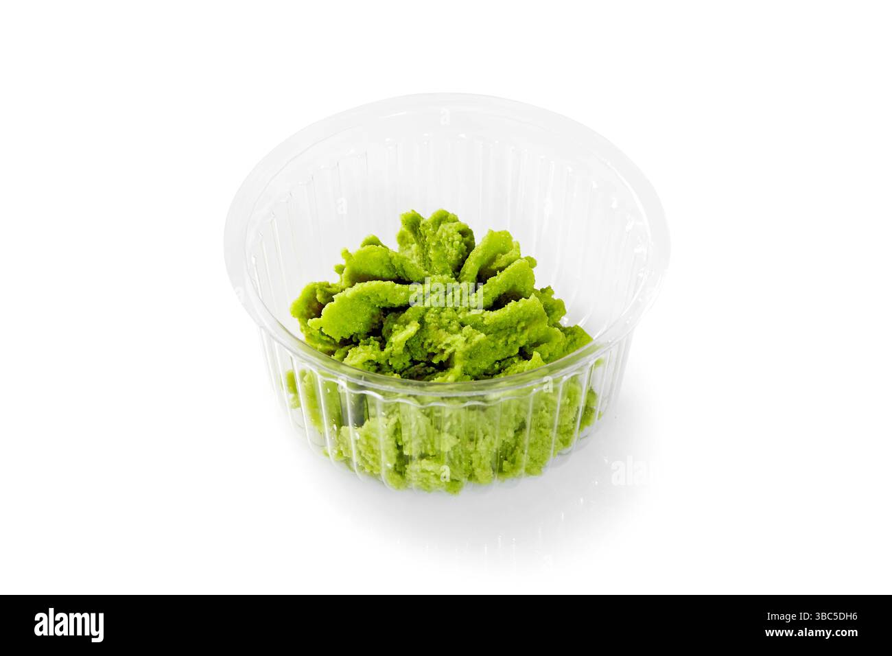 Wasabi paste in plastic container on white background Stock Photo - Alamy