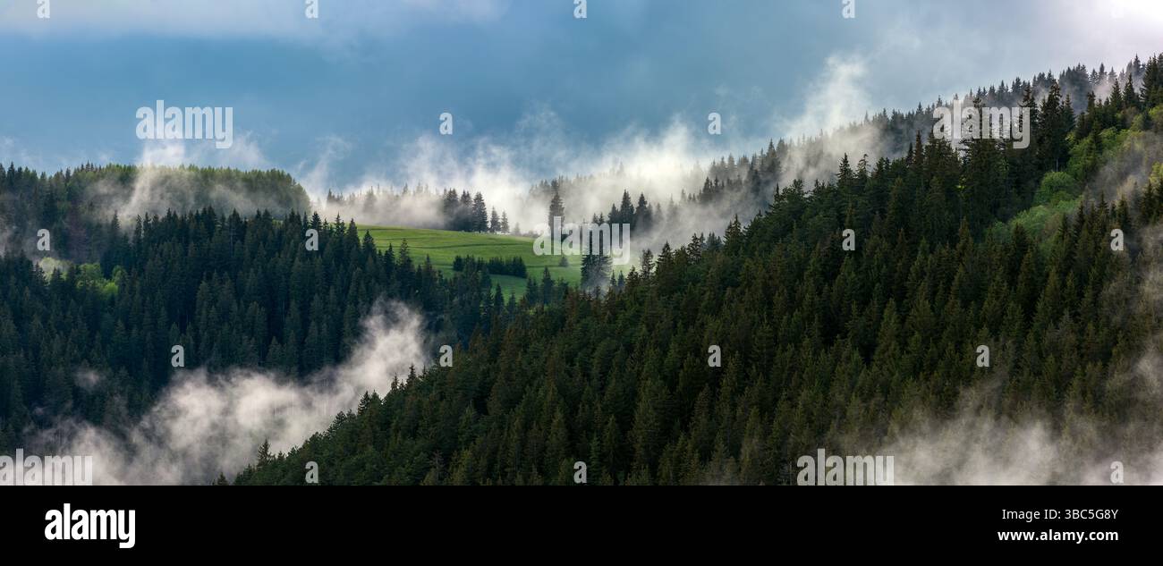 View of the mountains that are partially obscured by clouds, right ...