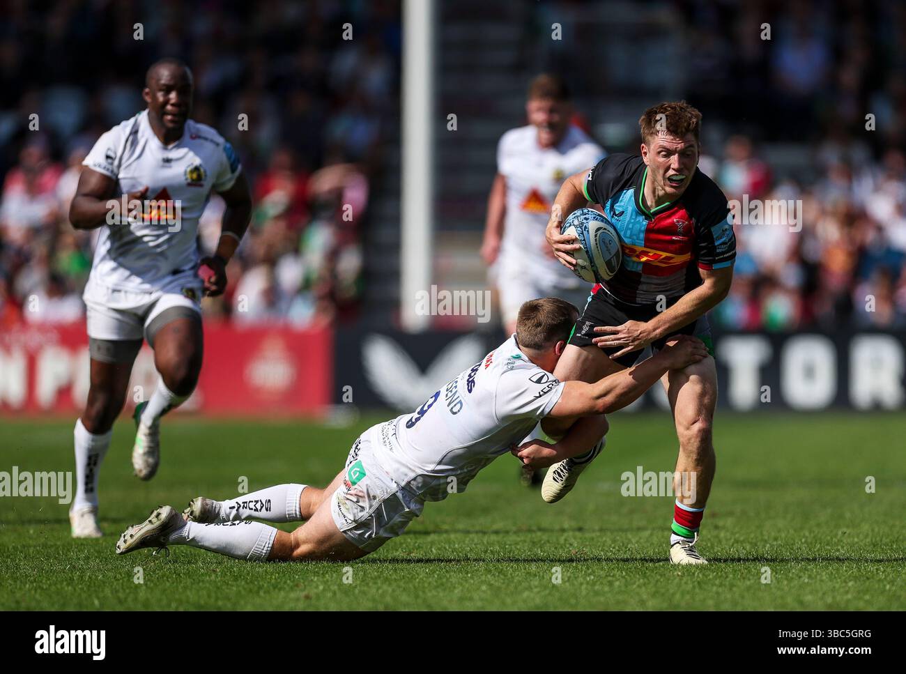 Harlequins' Will Porter (right) is tackled by Exeter Chiefs' Stu ...