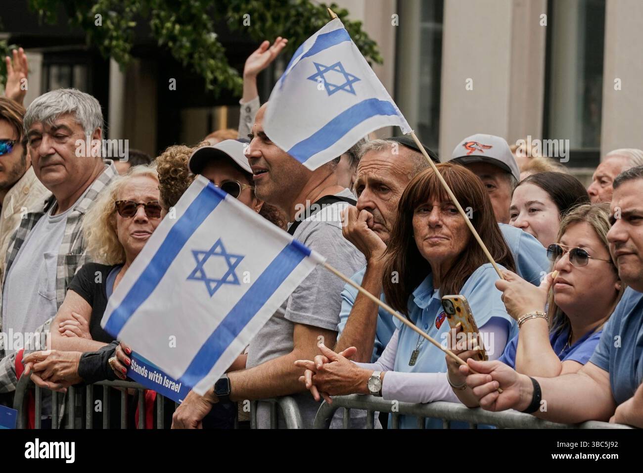 Spectators watch the 2025 Israel Day Parade, on New York's Fifth Avenue ...