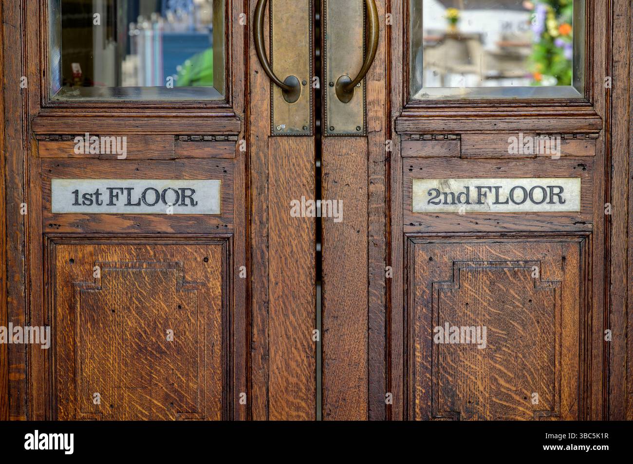 First and second floor signs on external wooden doors, UK Stock Photo ...