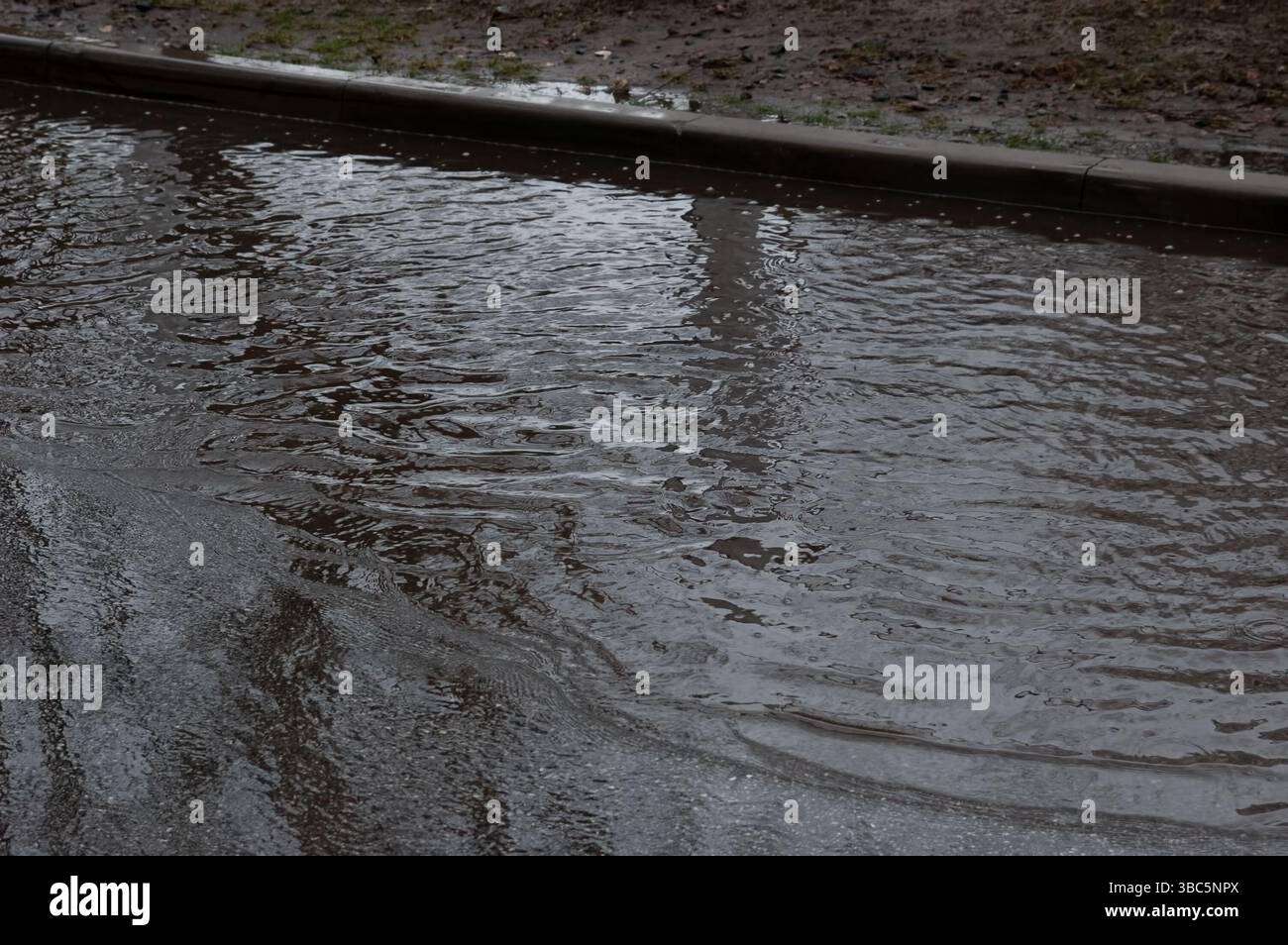 the waves run in a deep, dark puddle Stock Photo - Alamy