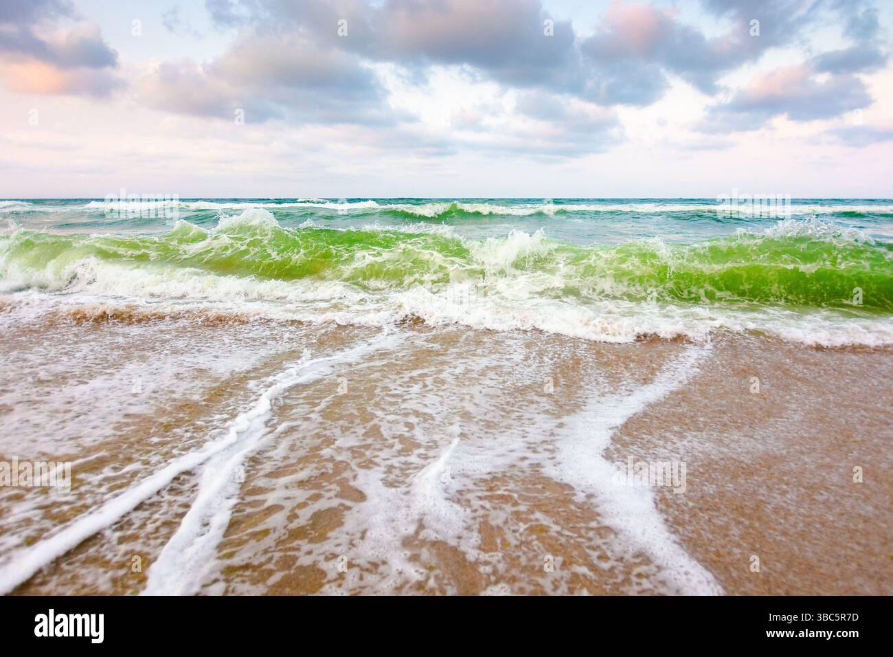 nature background with sea tide in evening light. water surface motion ...