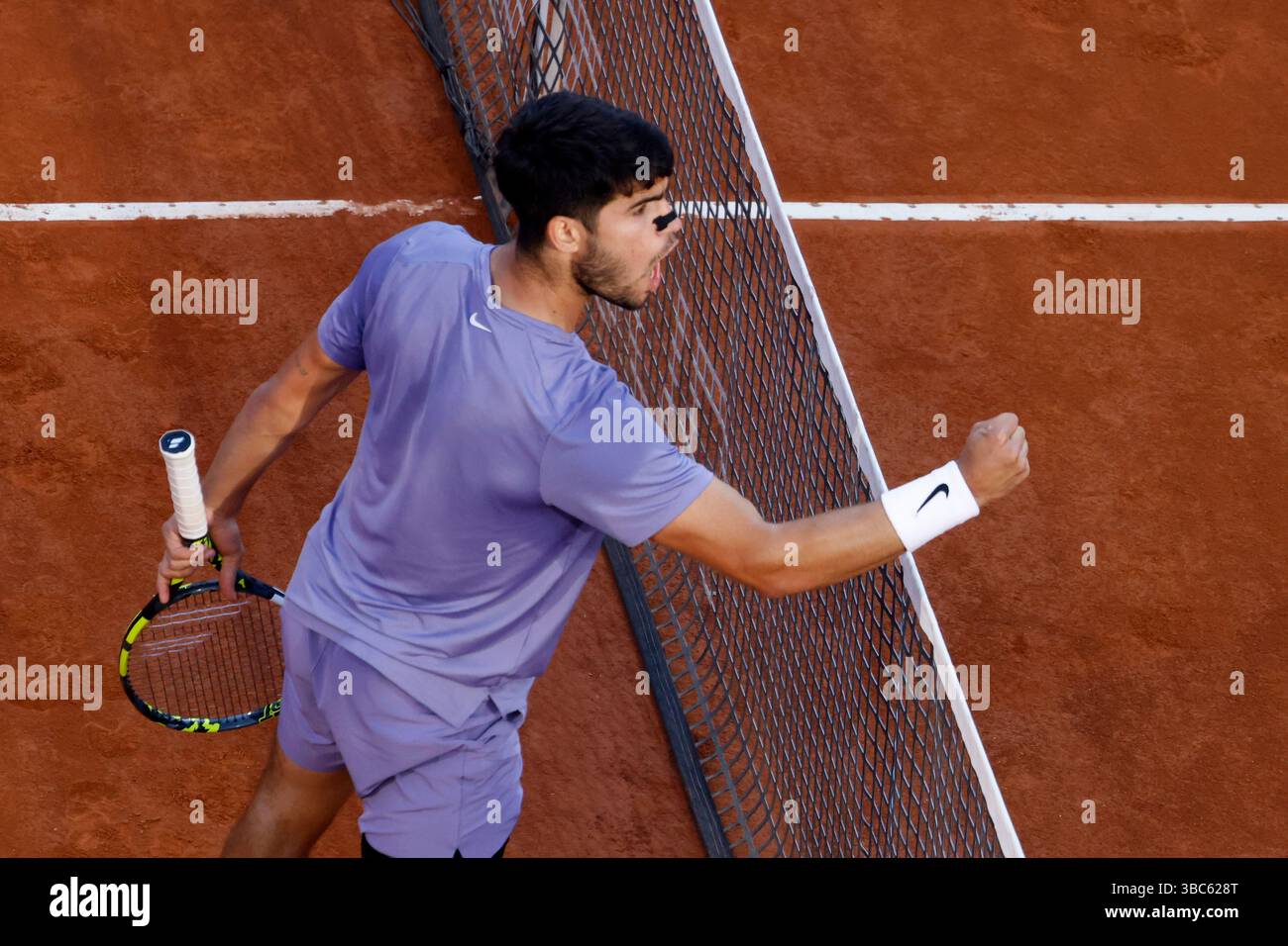 Rome, Italy. 18th May, 2025. Spain's Carlos Alcaraz reacts after winning a point against Italy's ...