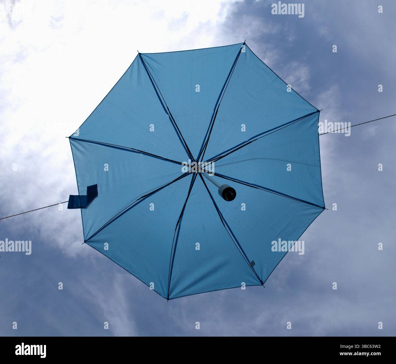 Blue, yellow, purple umbrella suspended, hanged upward shot the sky ...