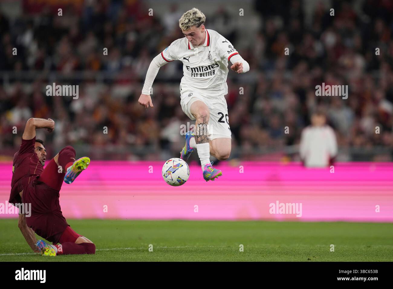 AC Milan's Alex Jimenez, right, and Roma's Zeki Celik battle for the ...
