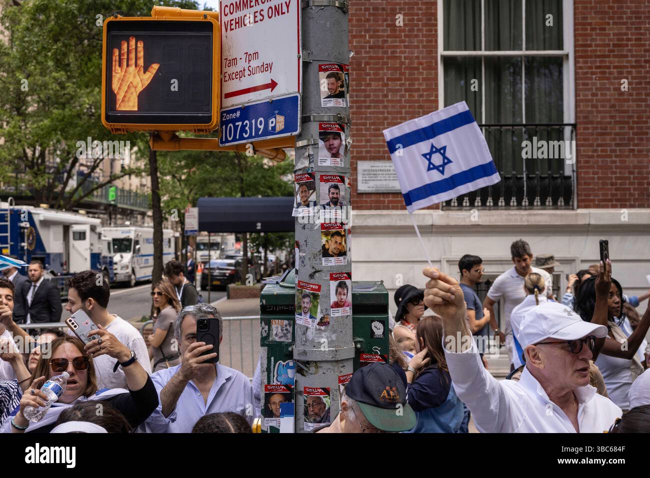 People raise Israeli flag as former hostage families and supporters ...