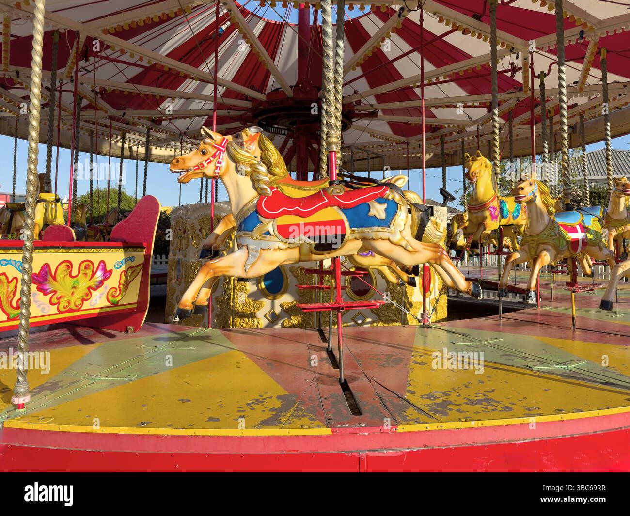 A fairground carousel horse ride attraction Stock Photo - Alamy