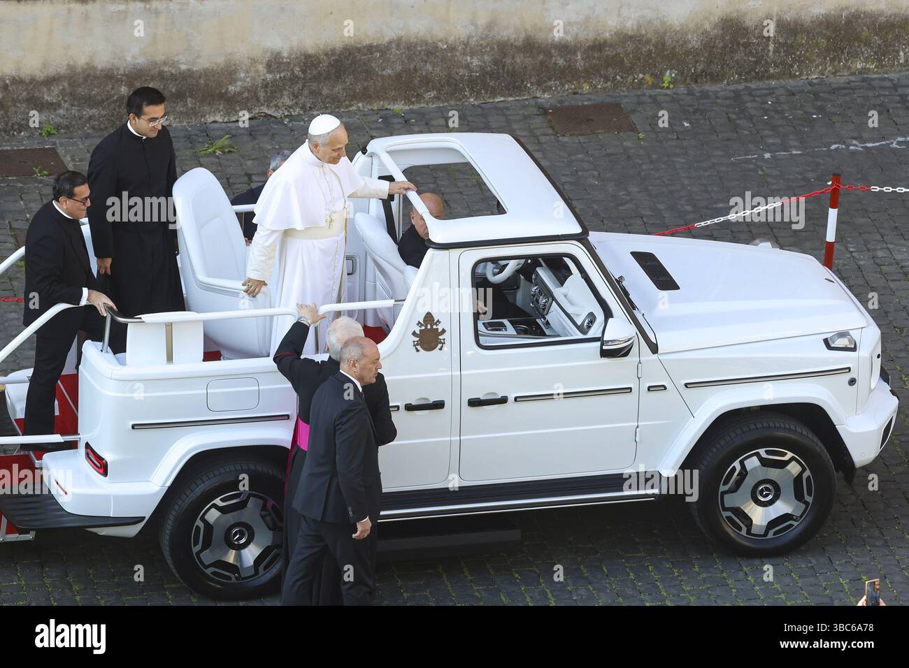 Pope Leo XIV climbs into the popemobile before entering St. Peter's ...
