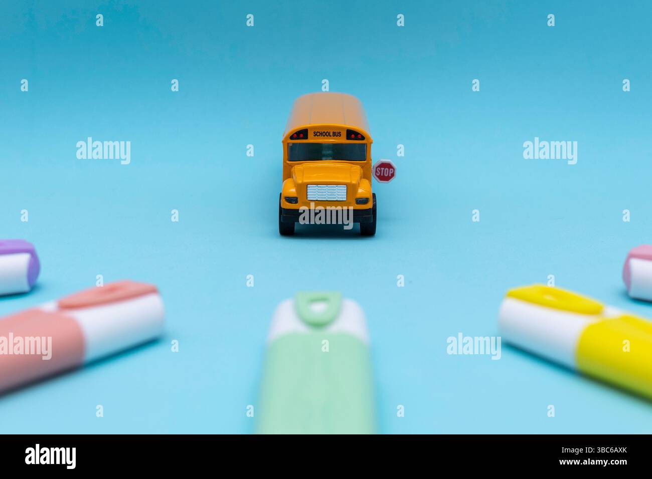Toy yellow school bus seen from the front with a visible stop sign ...