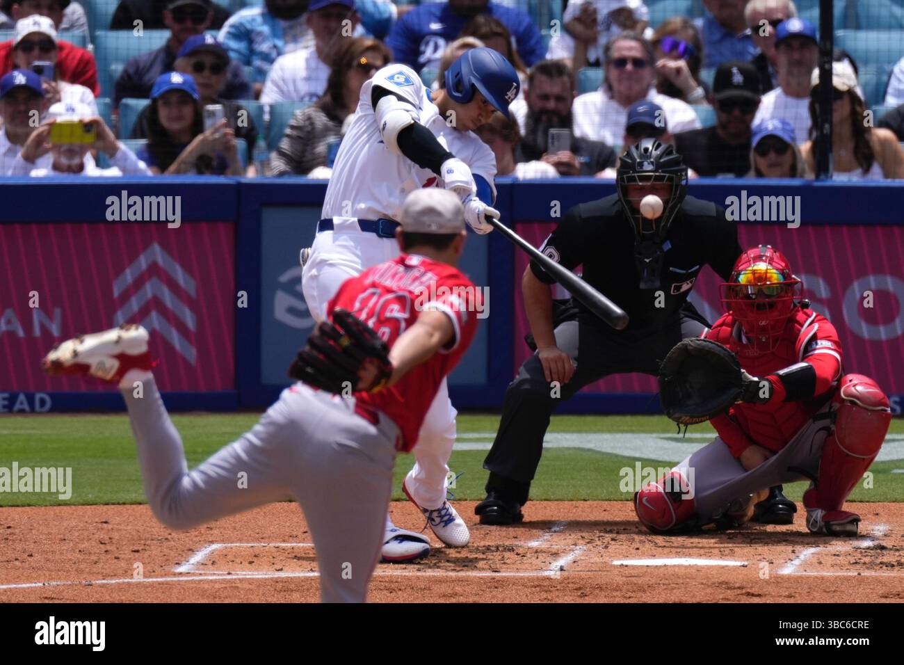 Los Angeles Angels starting pitcher Yusei Kikuchi, left, pitches to Los ...