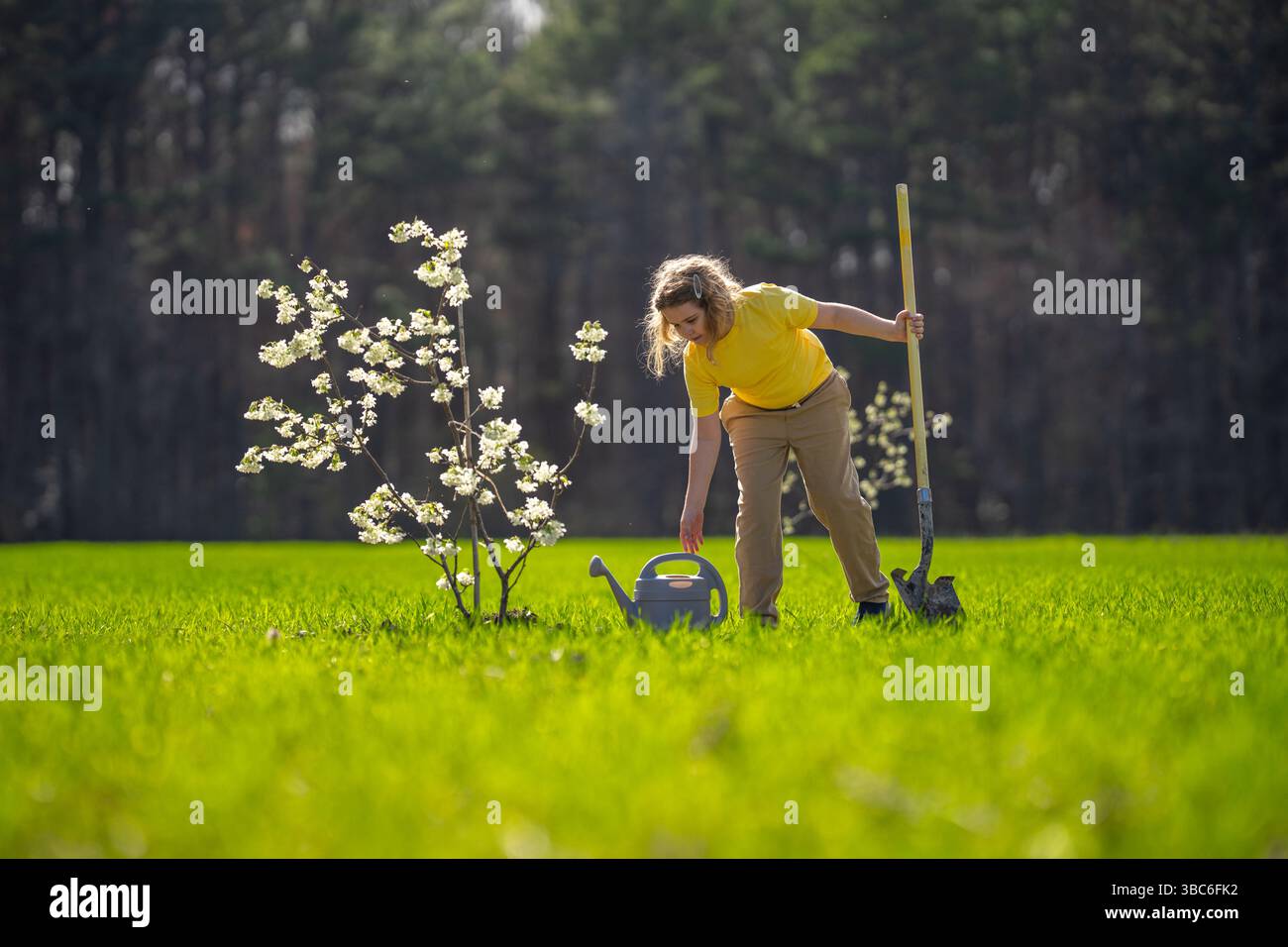 Child working in the garden yard. Growth tree and care plant for the ...