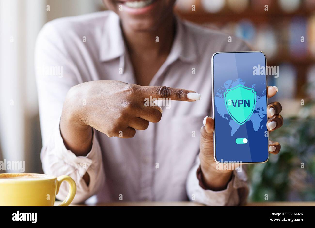 VPN App. Black Woman Pointing At Smartphone With Virtual Private ...