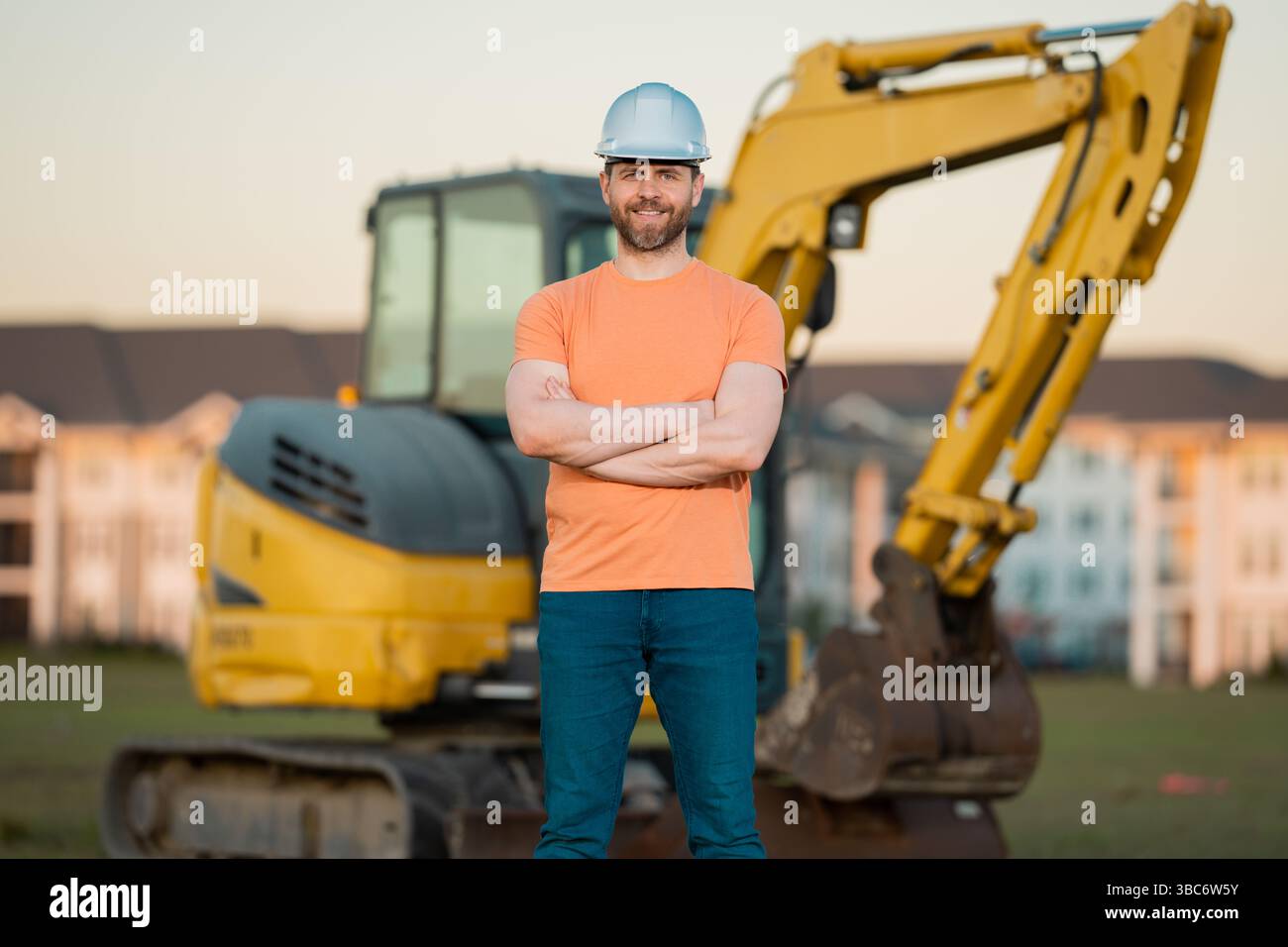 Builder in a construction site. Builder with excavator ready to build ...