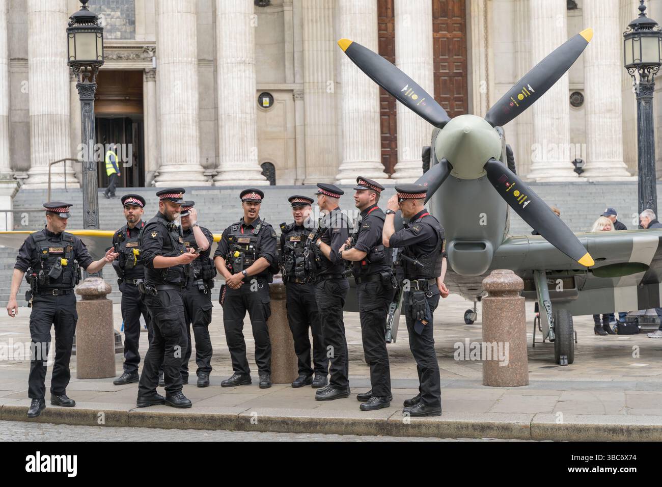 City of London Police officers stand beside Spitfire models stationed ...
