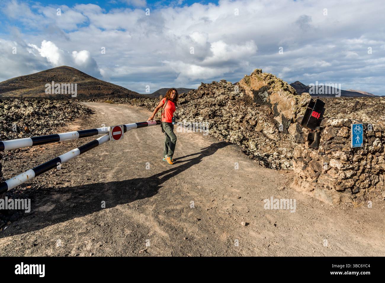 A hiking guide opens a path barrier in Mancha Blanca on the Canary ...