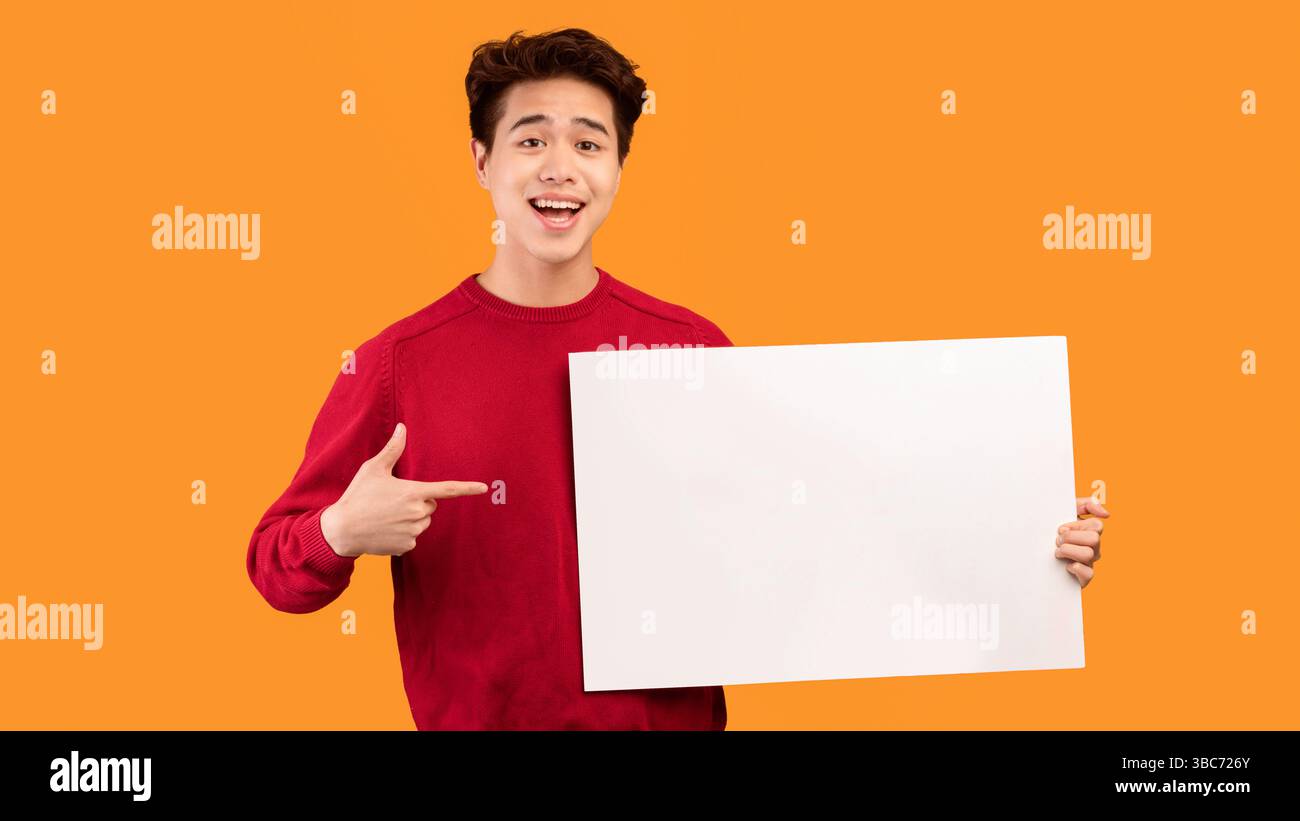 Asian guy holding blank white advertising board Stock Photo - Alamy