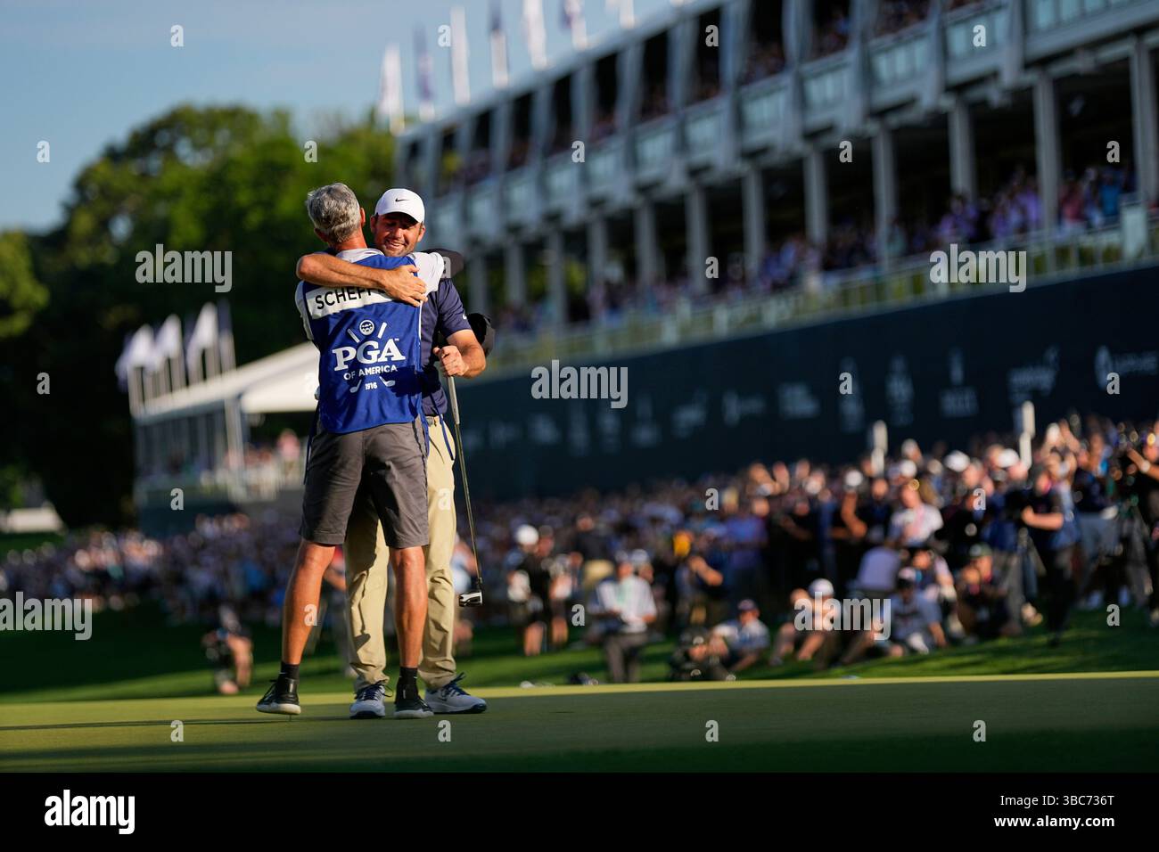 Scottie Scheffler hugs his caddie Ted Scott after winning the PGA ...