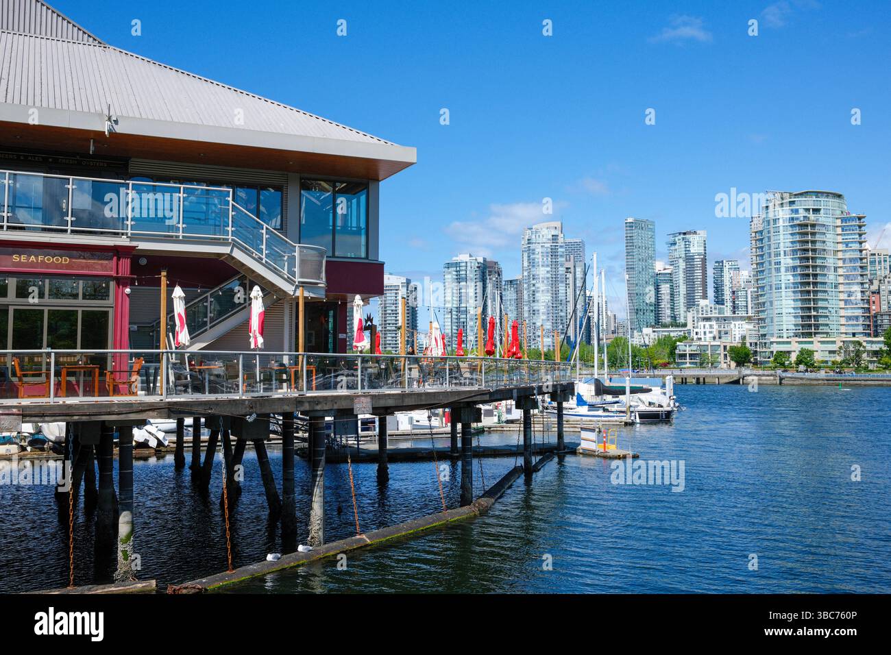 A pier by the old Monk McQueen's restaurant (now Bae Side by False Creek) along the Seawall ...