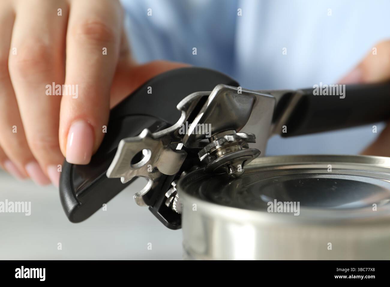 Woman opening tin can opener hi-res stock photography and images - Alamy