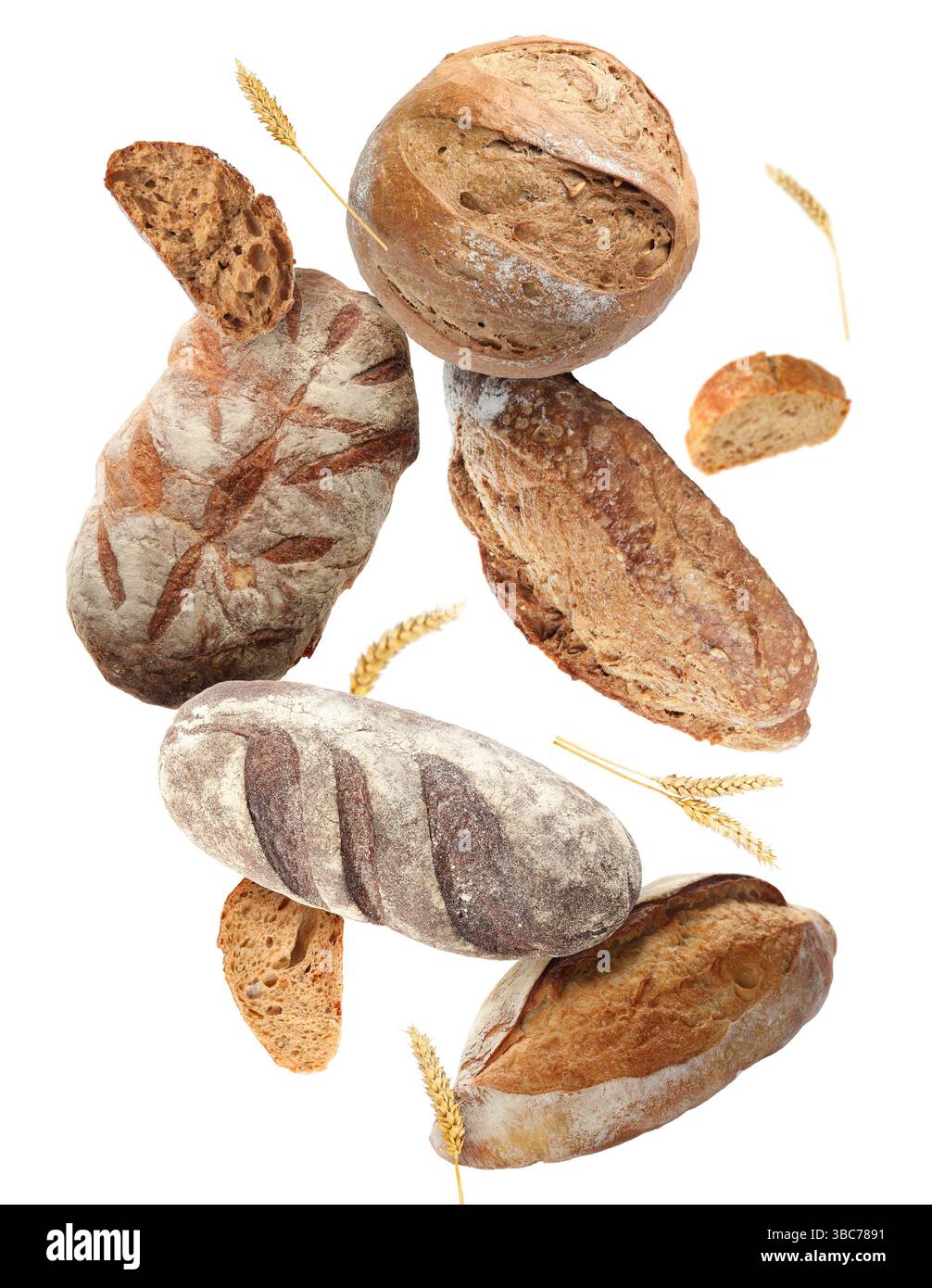 Different types of bread and spikes falling on white background Stock ...