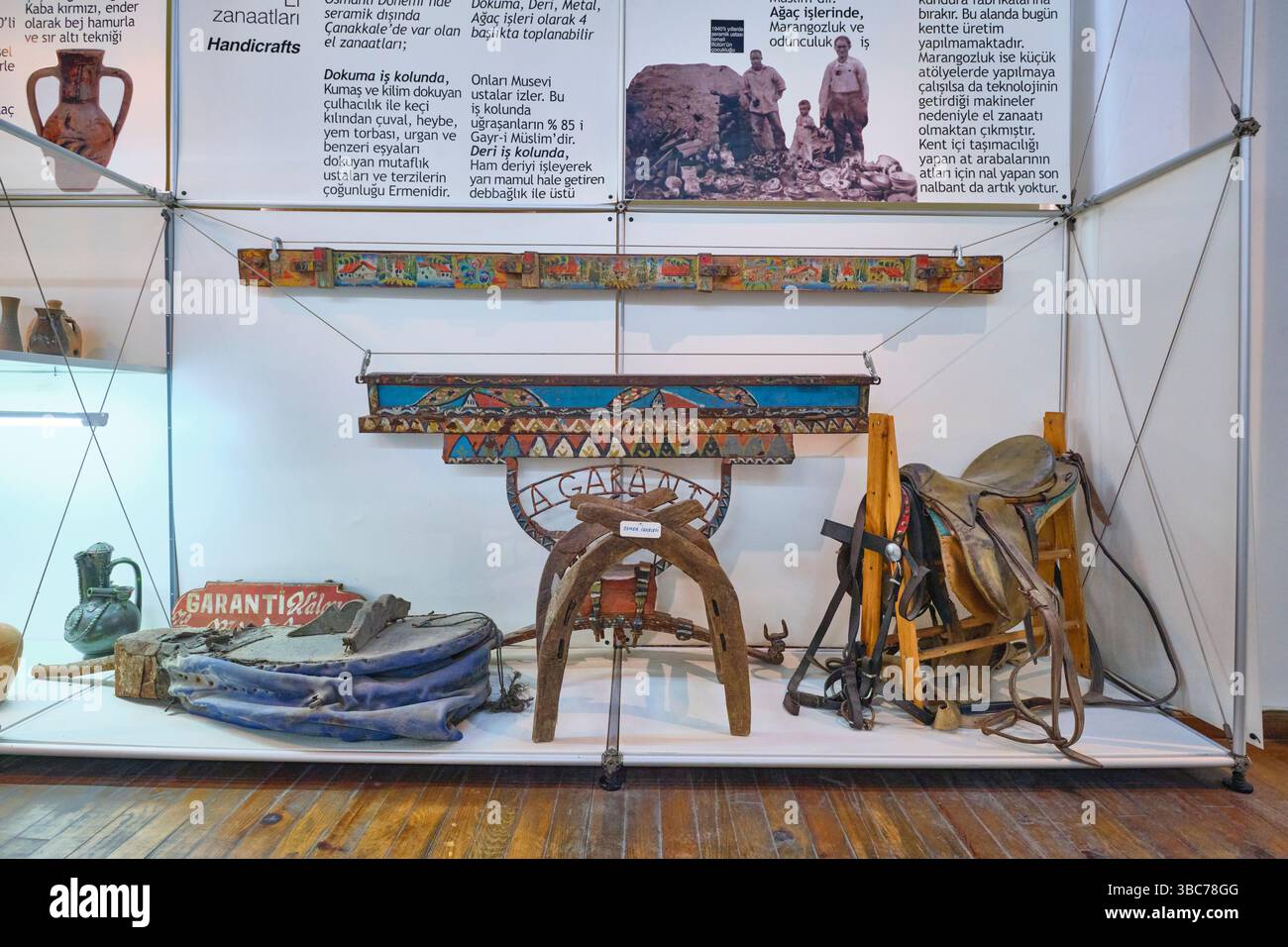 An old bellows, saddles and old, painted wagon items. At the City ...