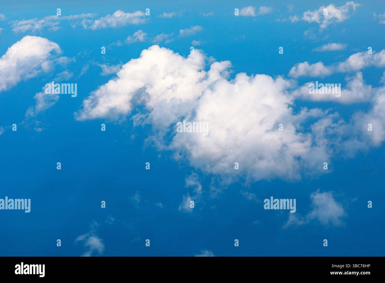 Clouds drift across a deep azure sky over the sea. Breathtaking ...