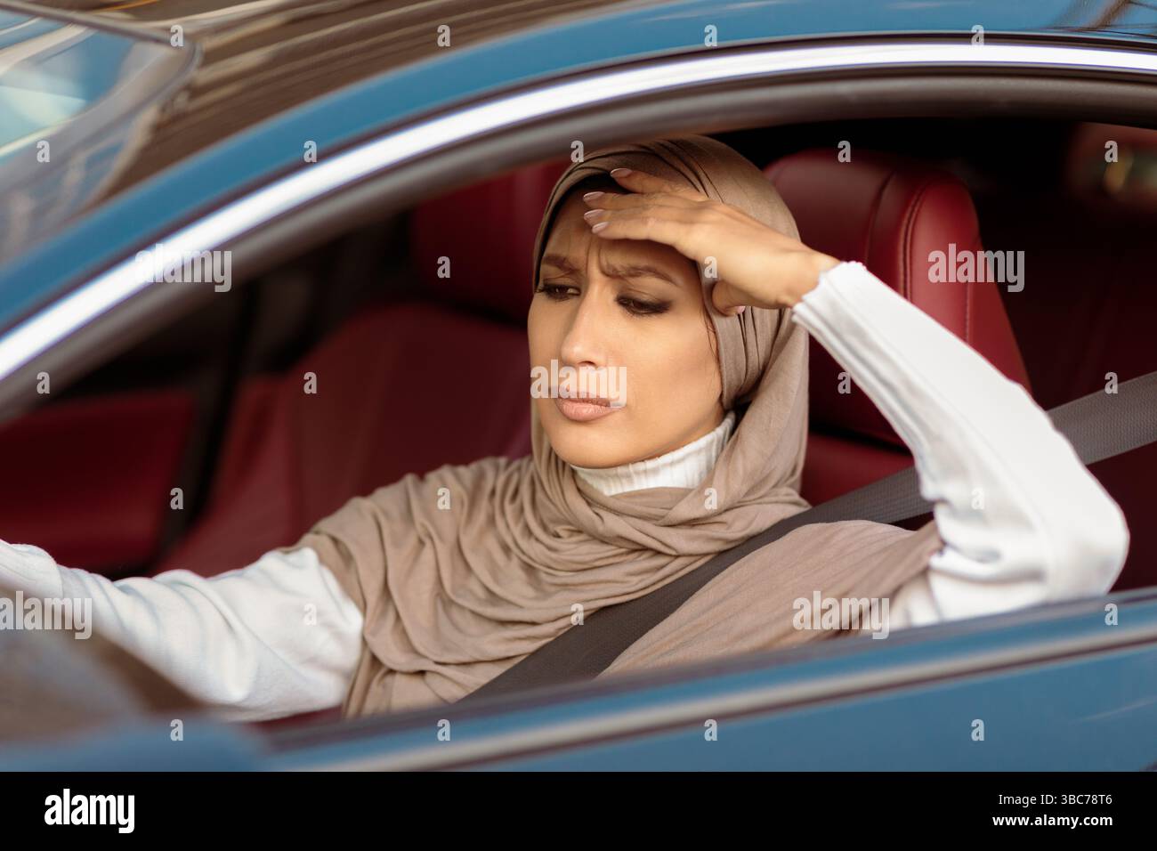 Upset muslim woman driving alone in her new car Stock Photo - Alamy